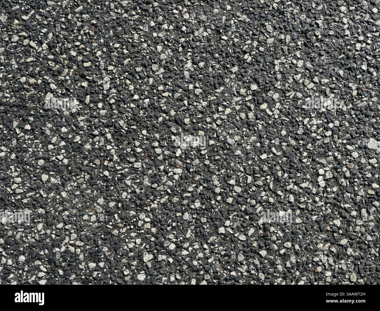 Asphalt road surface with white gravel ensures grip and safety ...