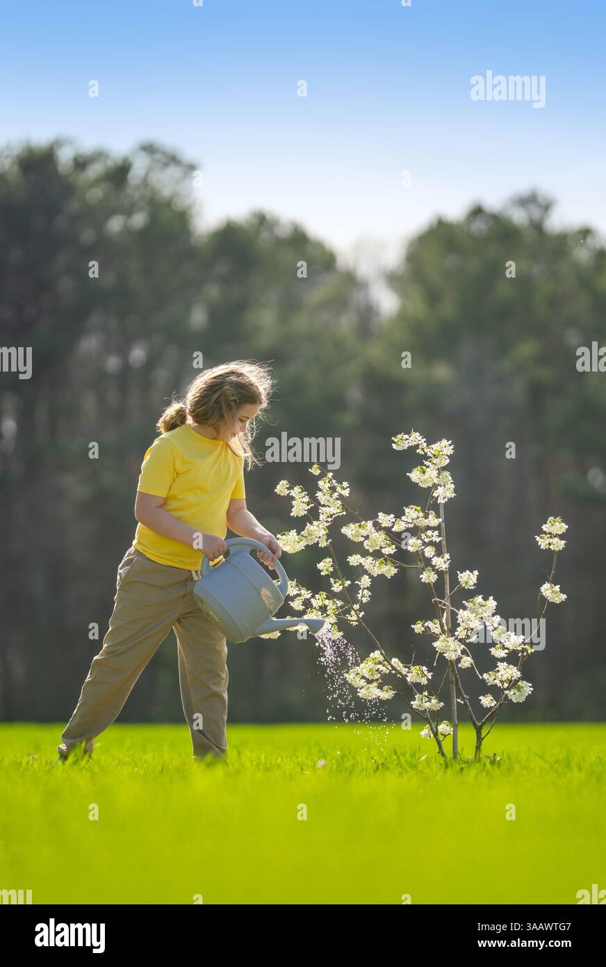 Kid planting a tree in garden. Kid digging soil with shovel and ...