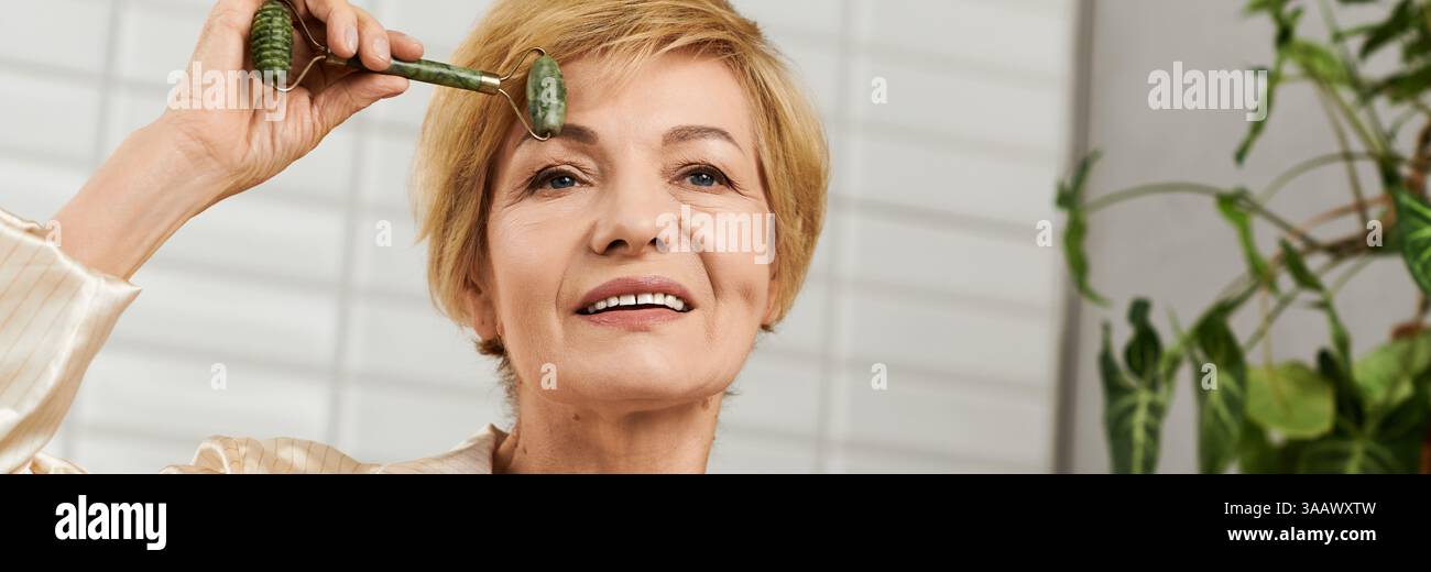 Mature woman applies a jade roller to her face, embracing self care and ...