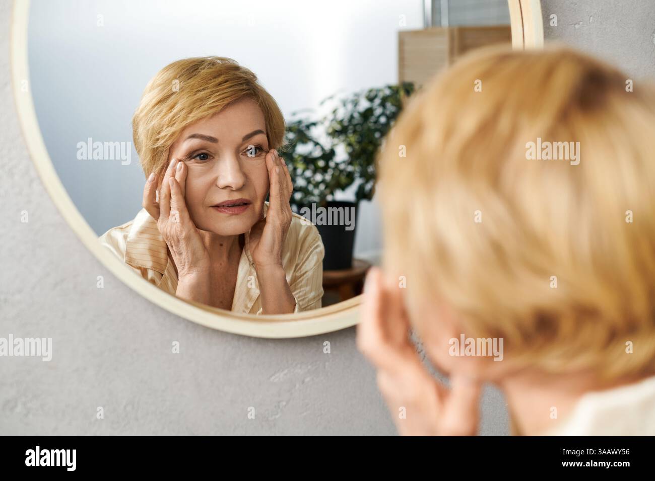 In a serene setting, a lovely senior woman thoughtfully admires her ...