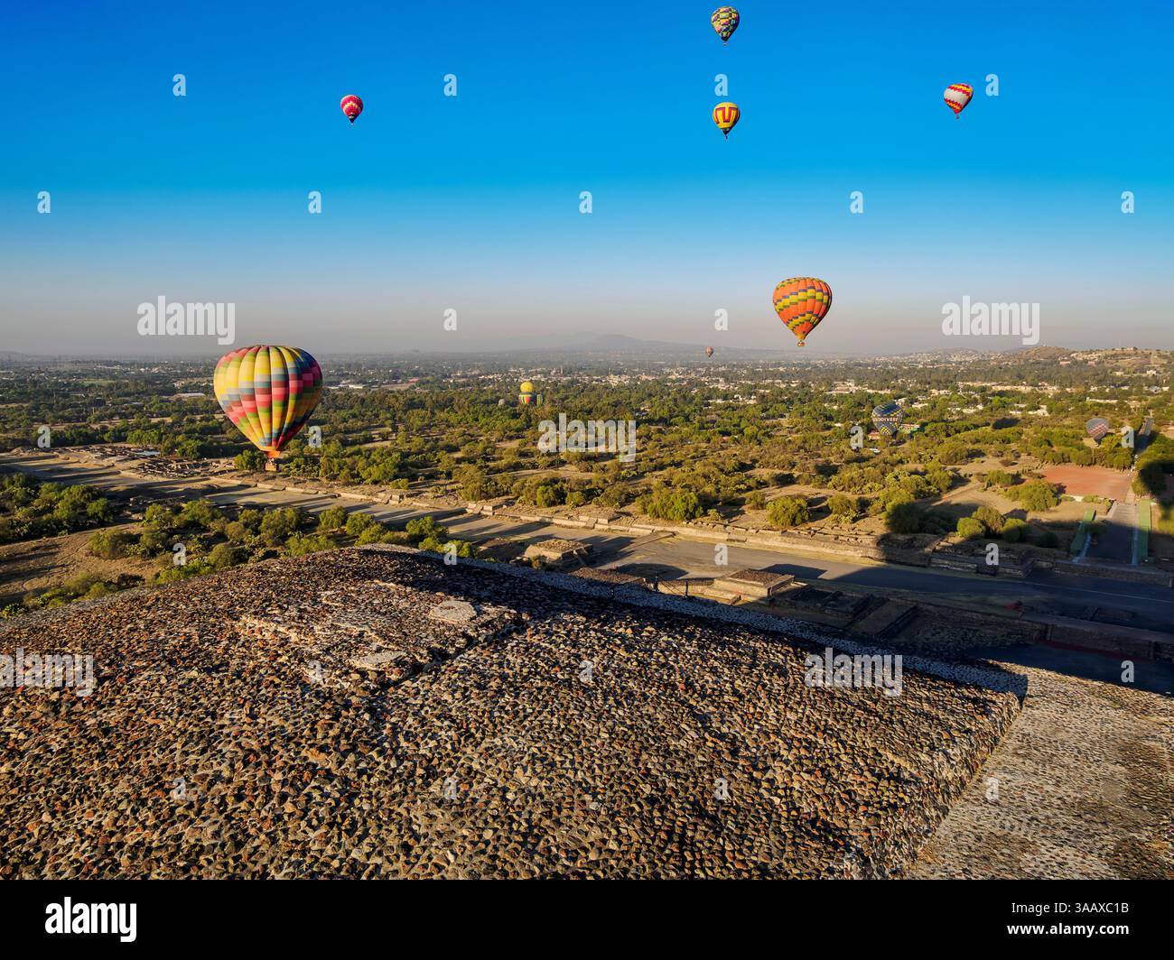 Hot air balloons flying over the Pyramid of the Sun at sunrise, aerial ...