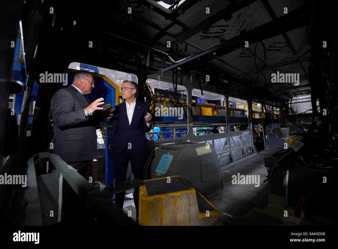 Liberal leader Mark Carney tours a bus factory with Paul Soubry ...