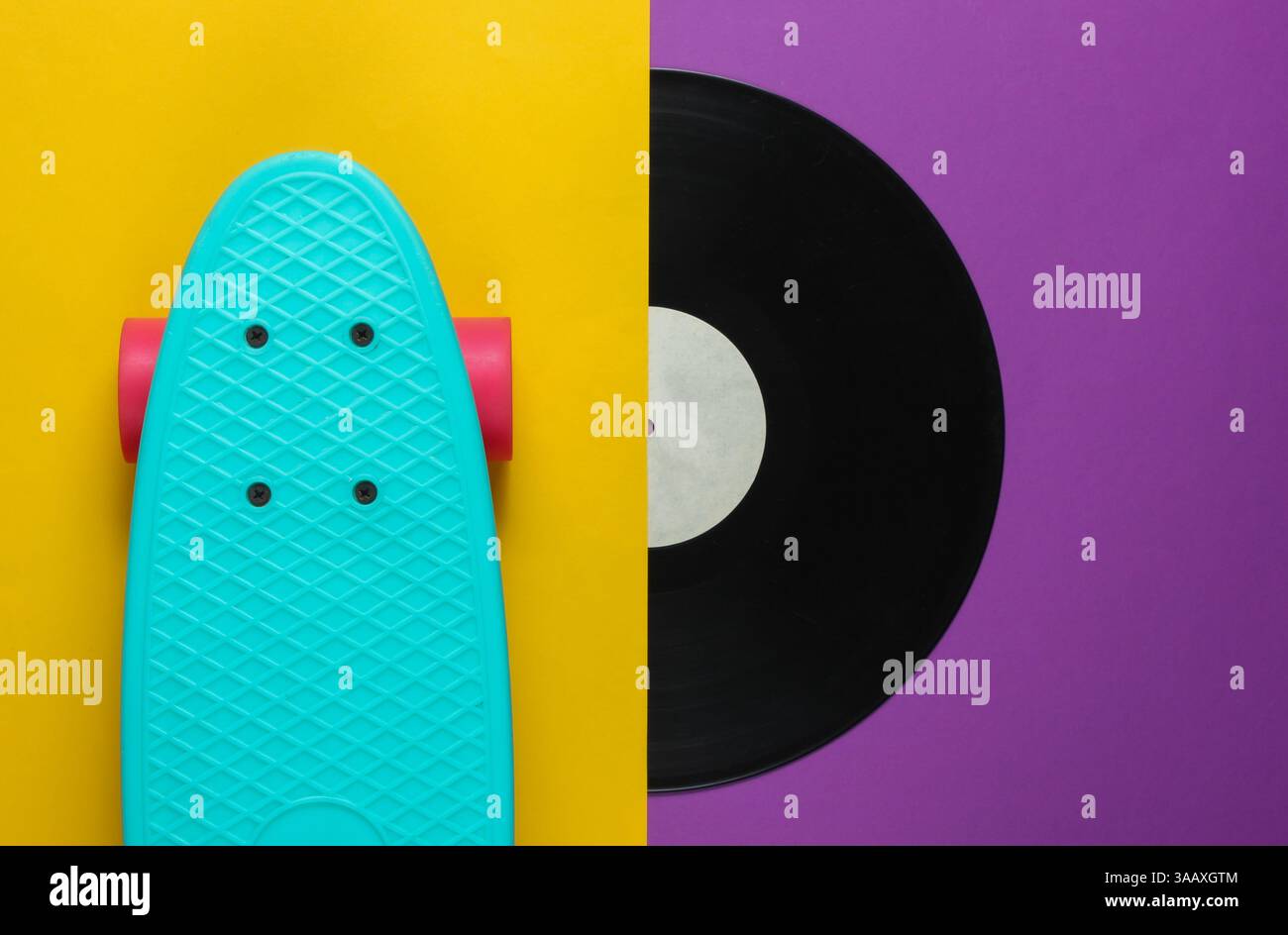 Cruiser board and vinyl record on purple yellow background. Youth retro ...