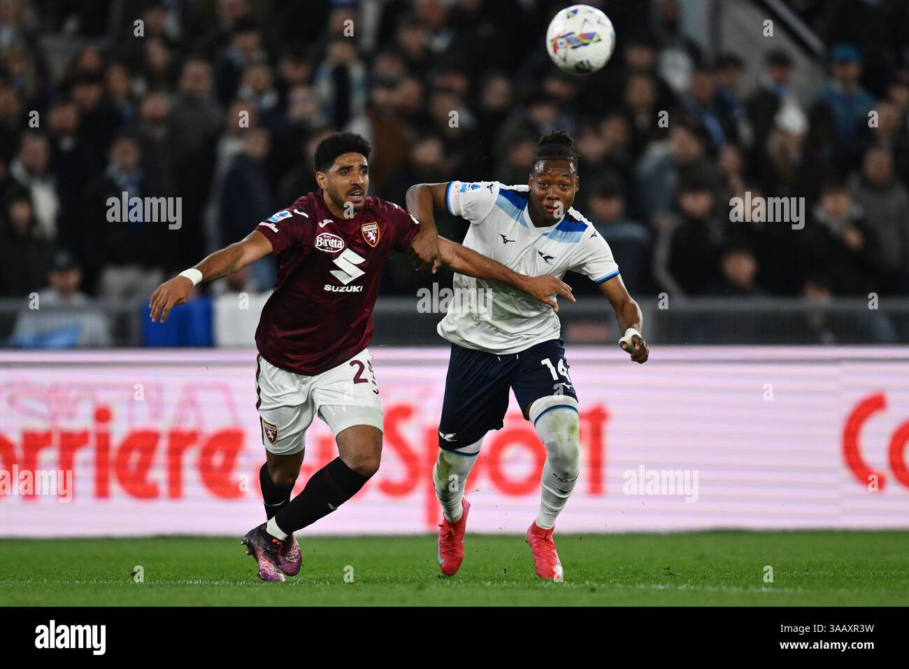 Saúl Coco of Torino F.C. and Tijjani Noslin of S.S. Lazio are in action ...