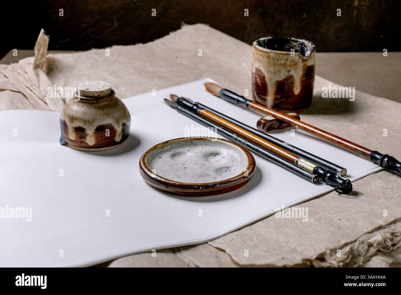 Traditional Chinese calligraphy tools arranged on white rice and ...