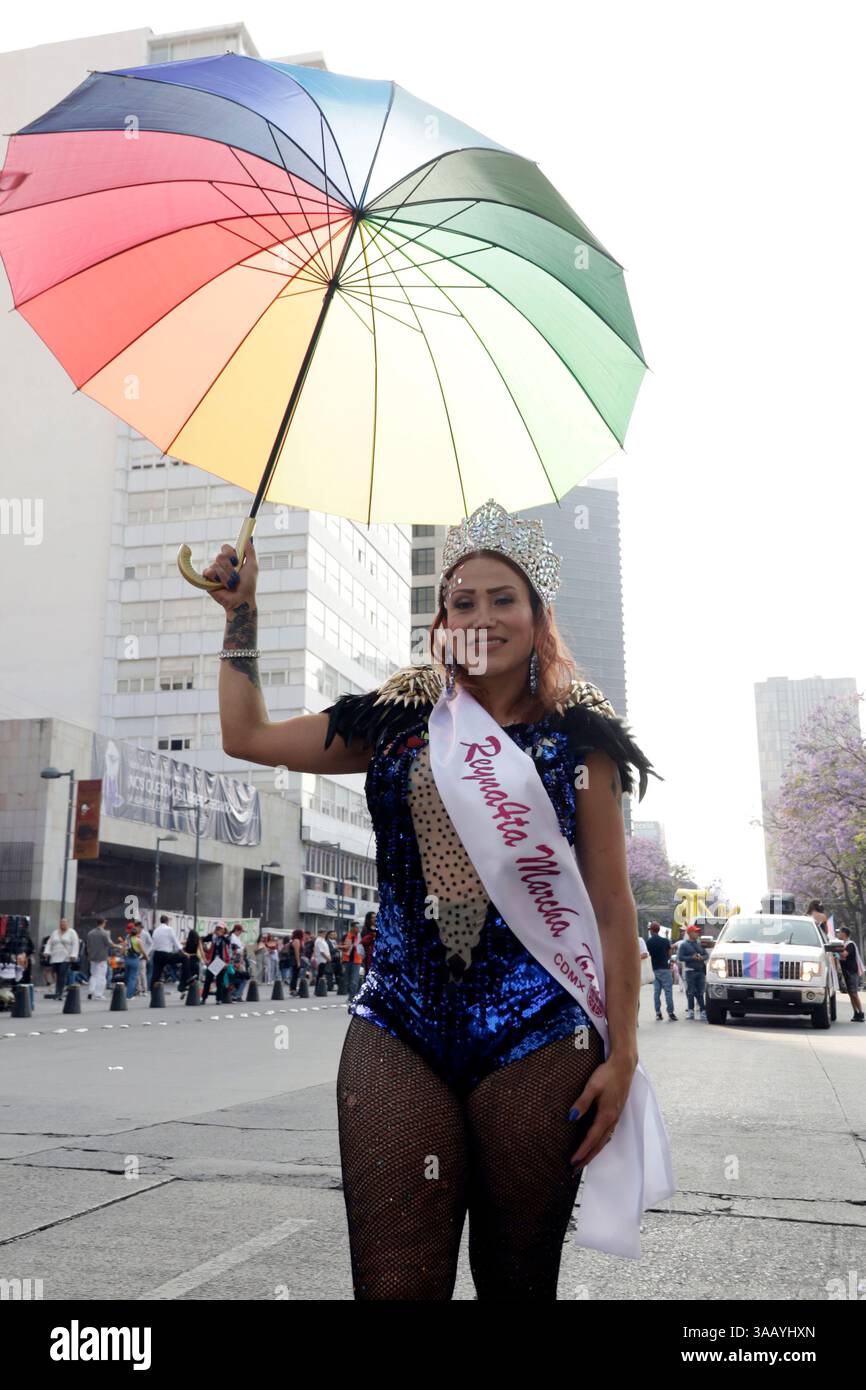 A member of the transgender community holding a rainbow umbrella during ...