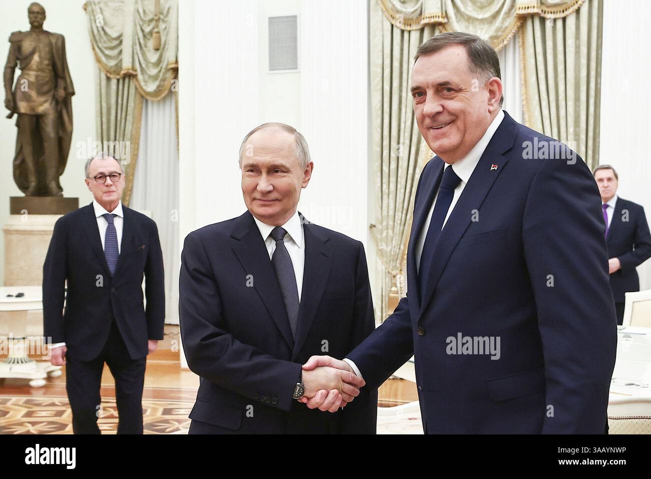 Russian President Vladimir Putin, center, and Bosnian Serb President Milorad Dodik shake hands ...