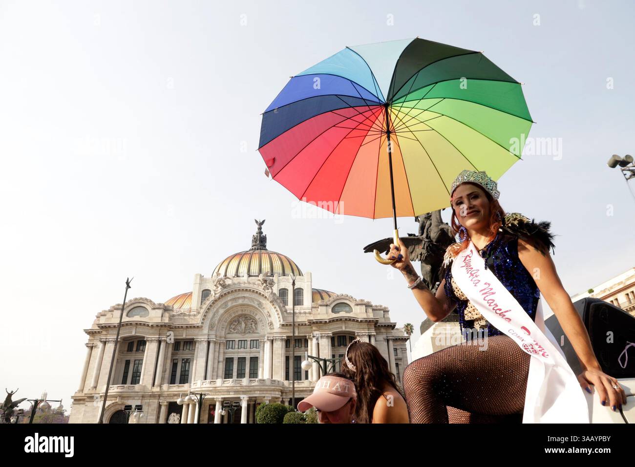 A member of the transgender community holding a rainbow umbrella during ...