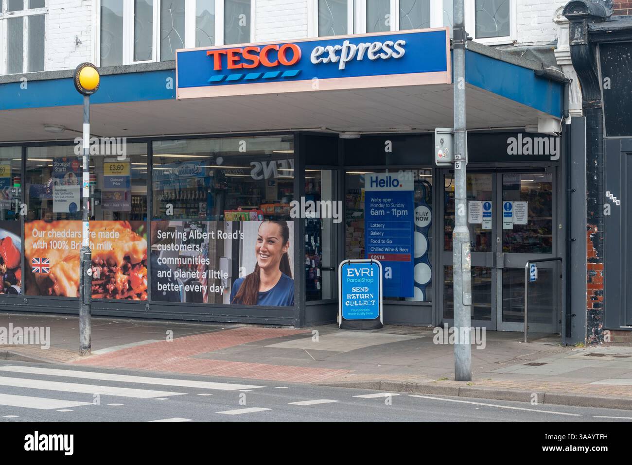 Tesco Express store entrance with a pedestrian crossing in front of it ...