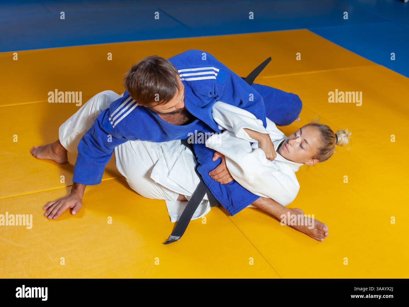 Martial arts. Sparing Portners. Sport man and woman in white and blue ...