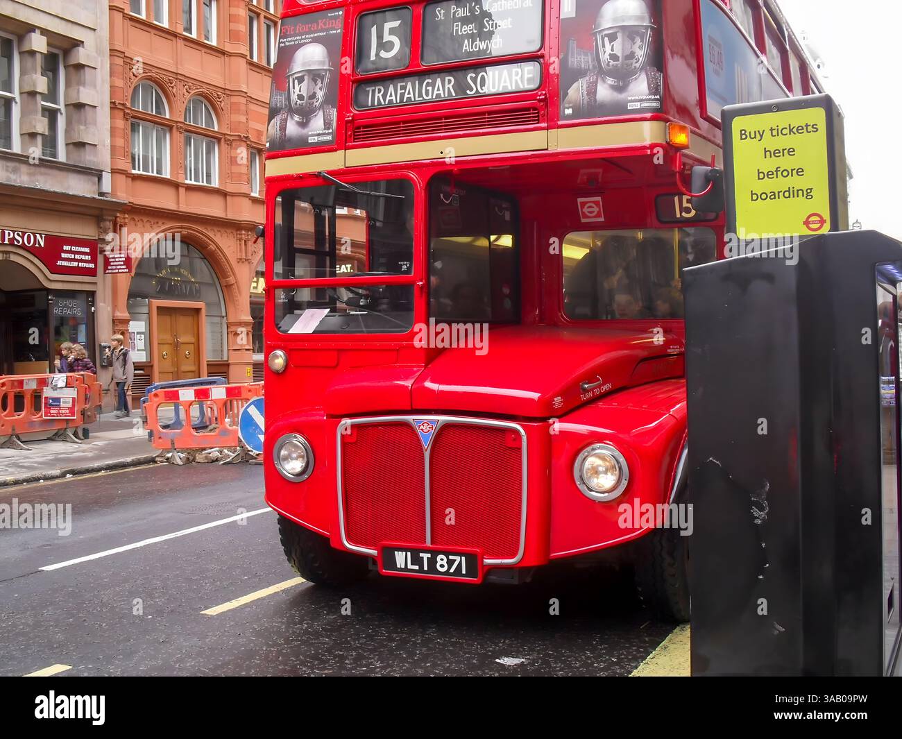 A classic red double-decker bus in London, displaying route number 15 ...