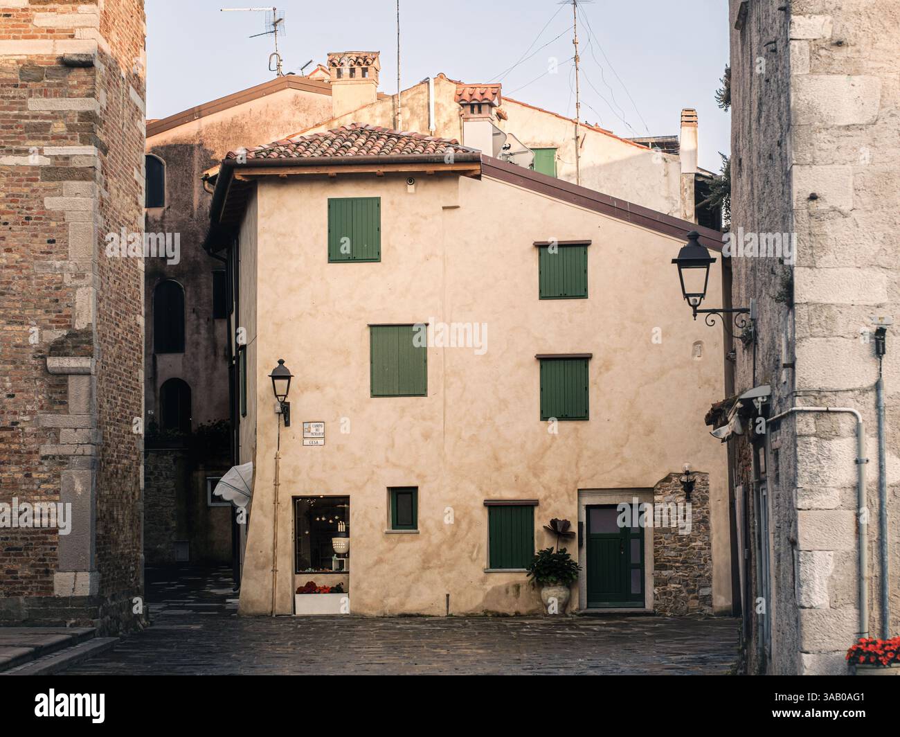 A picturesque historic house in Grado, Italy, with warm beige walls ...