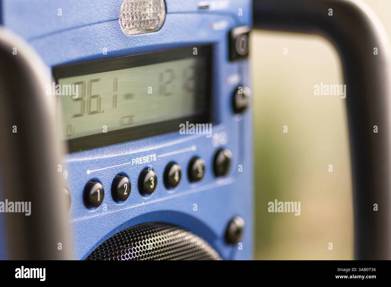 Close-up of a blue portable radio tuning display showing FM radio ...
