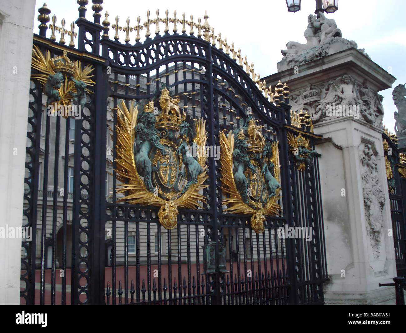 A close-up view of ornate wrought iron gates featuring intricate gold ...