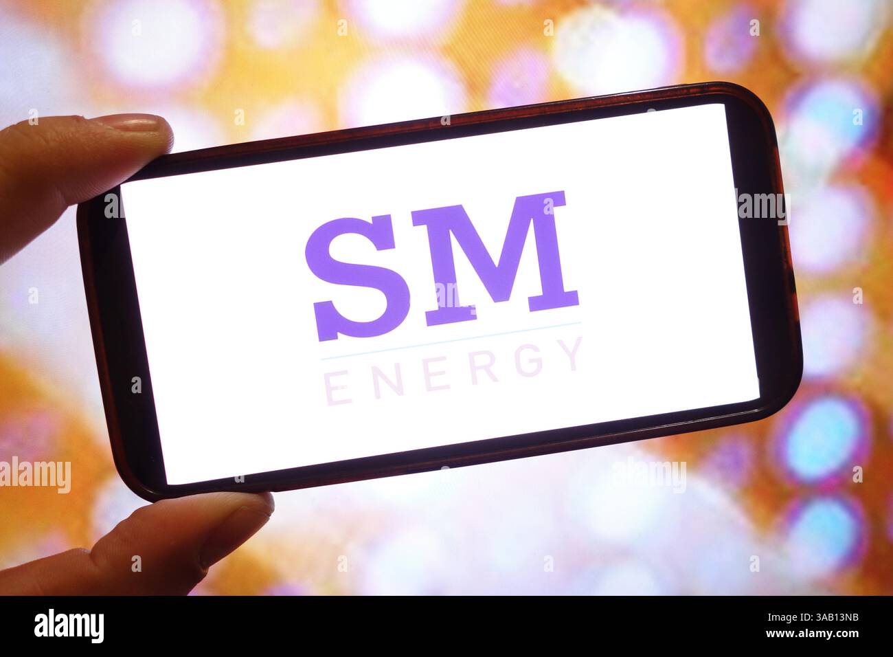 In this photo illustration, the SM Energy company logo is seen displayed on a smartphone screen ...
