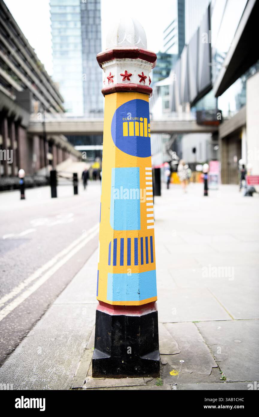 A yellow street bollard marking the Culture Mile, a business ...