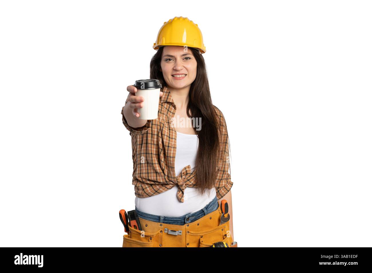A smiling female construction worker in a yellow hard hat and tool belt extends a takeaway ...