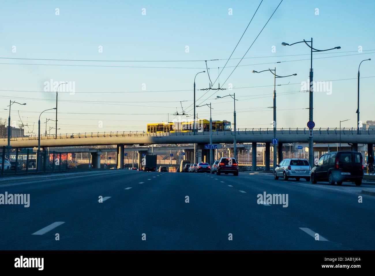 Belarus, Minsk - 25.02.2025: A bright yellow bus is traveling over a ...
