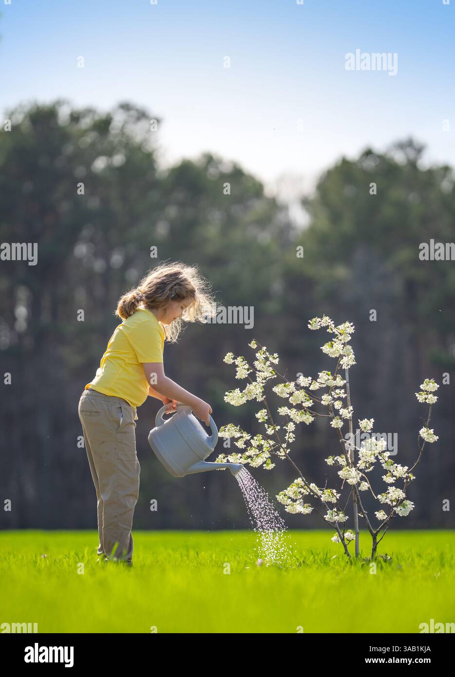 Child growing a tree in garden. Child digging soil with shovel and ...