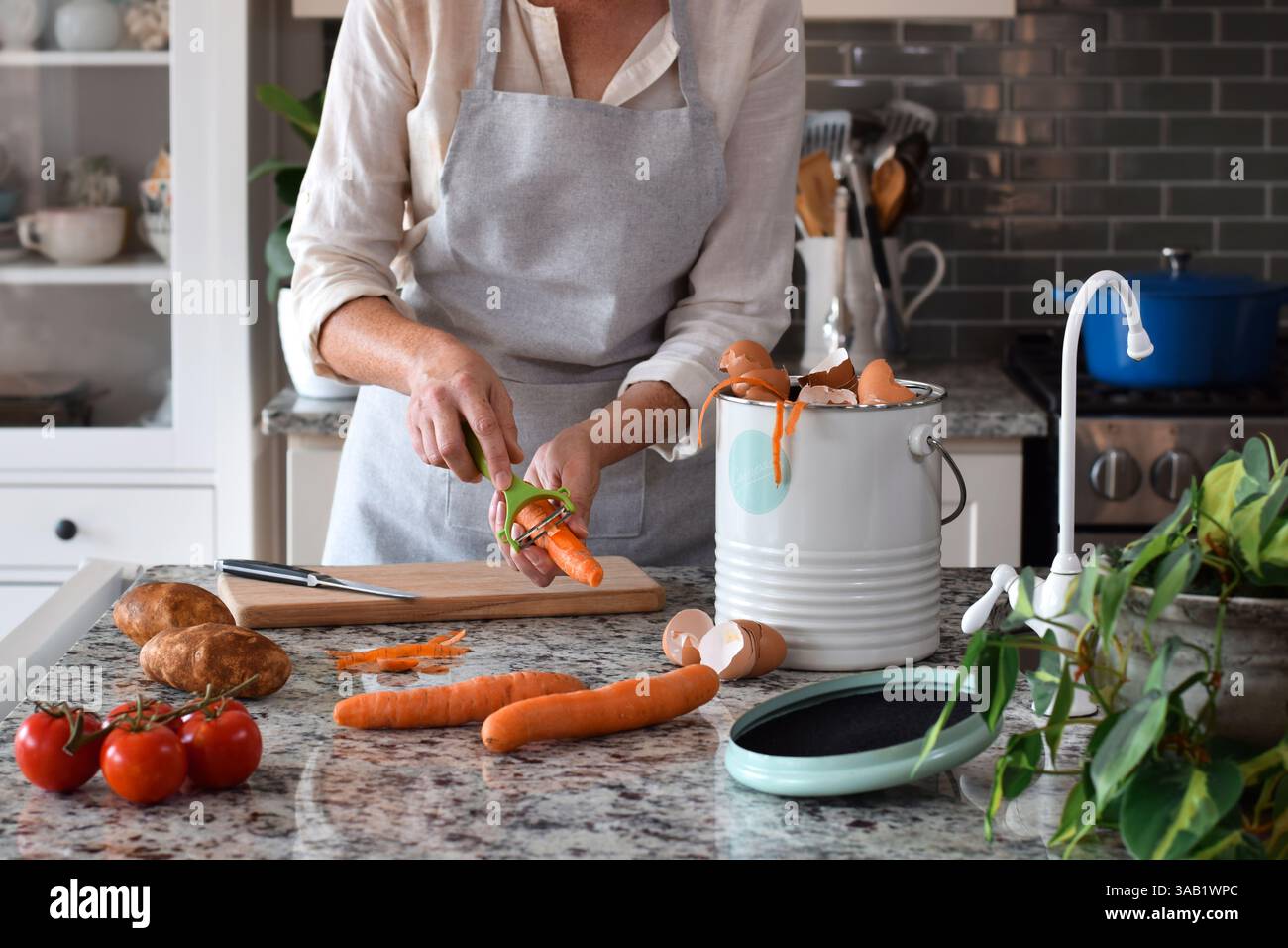 Woman peeling carrots kitchen counter hi-res stock photography and ...