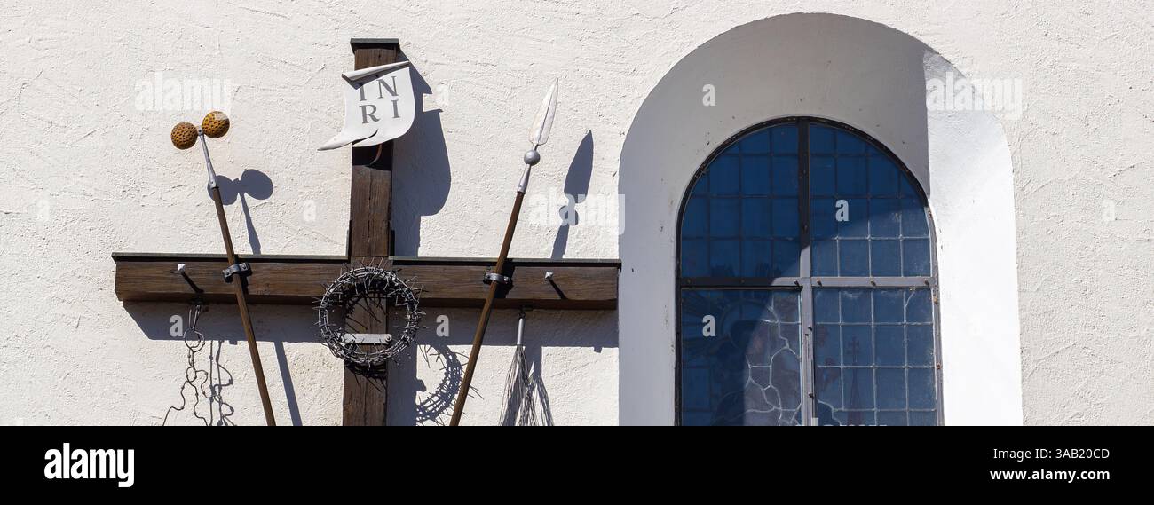 Old wooden cross of Jesus with instruments of torture on the wall of ...