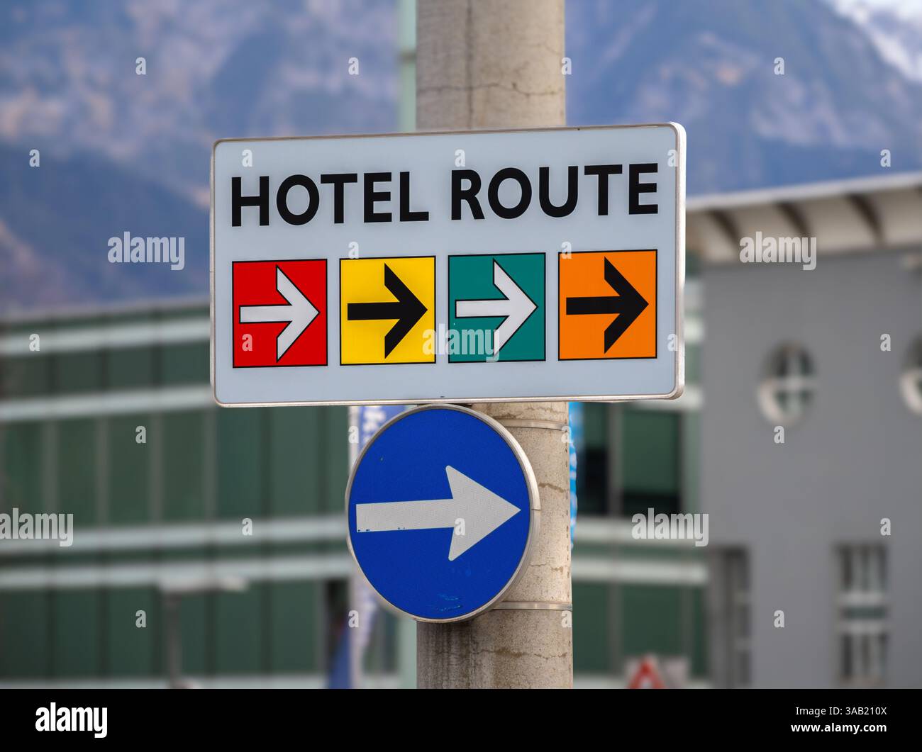 A directional sign indicating the Hotel route, featuring multiple ...