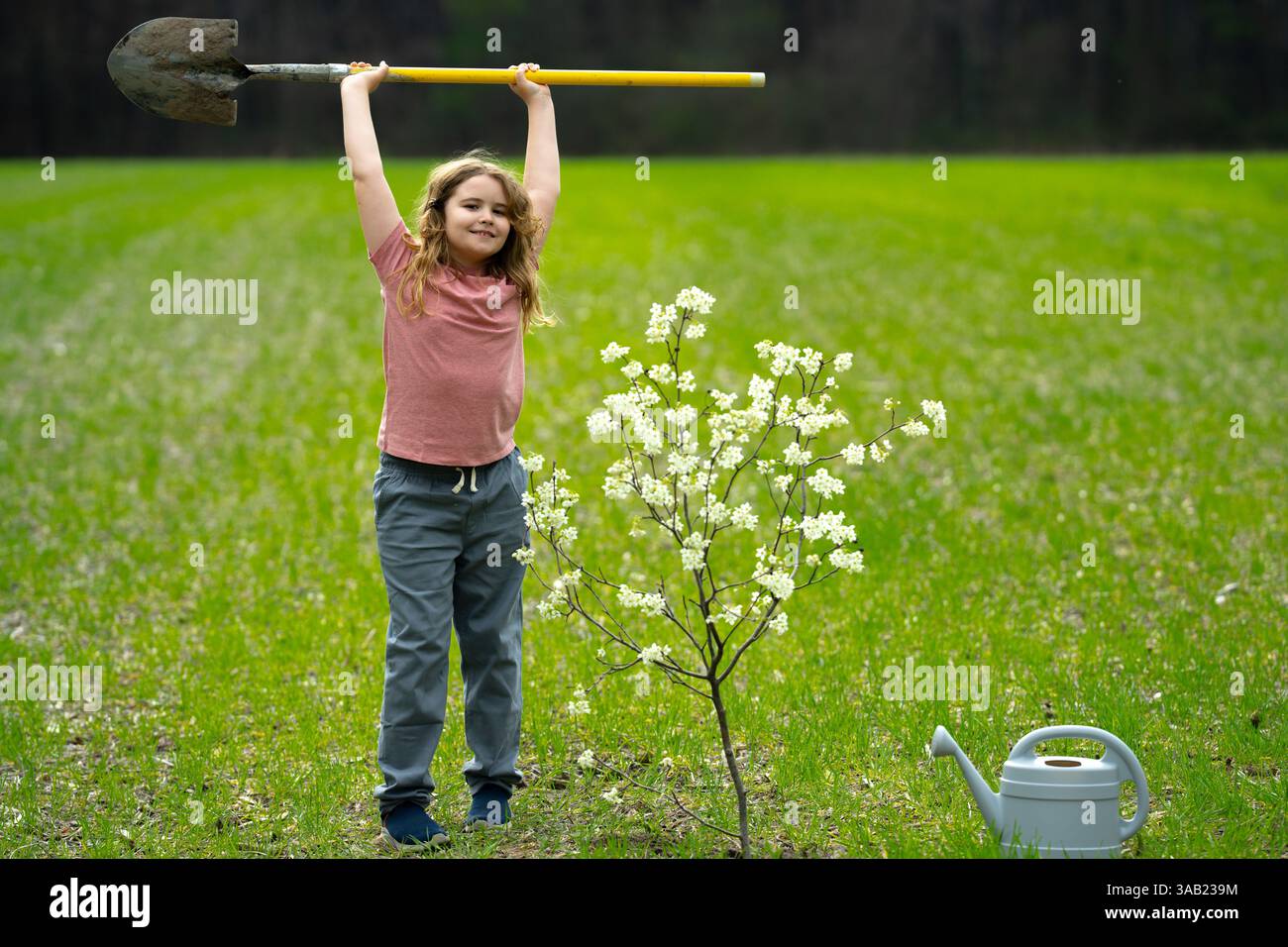 Child planting tree outdoors. Spring activity of plant trees. Kid work ...