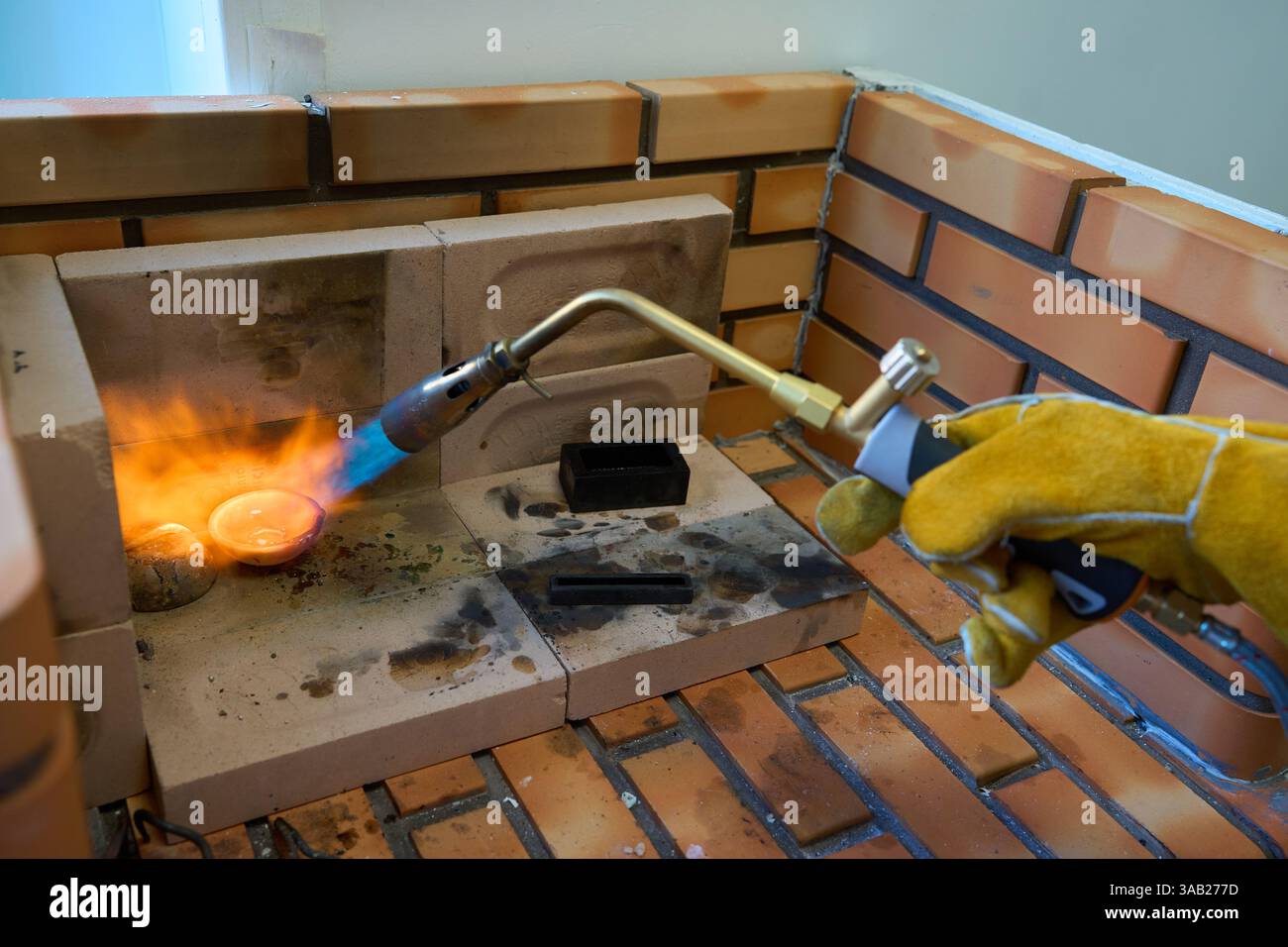 Jeweler melting gold with a gas welding torch in a small workshop Stock ...