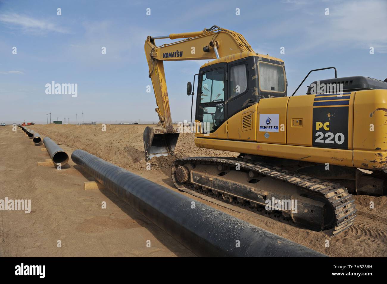 Excavator digs a trench for the construction of a gas pipeline Stock ...
