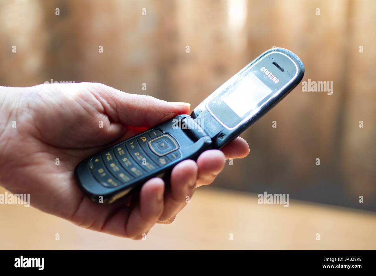 Belarus, Minsk - 09.03.2025: A person is currently holding an older ...