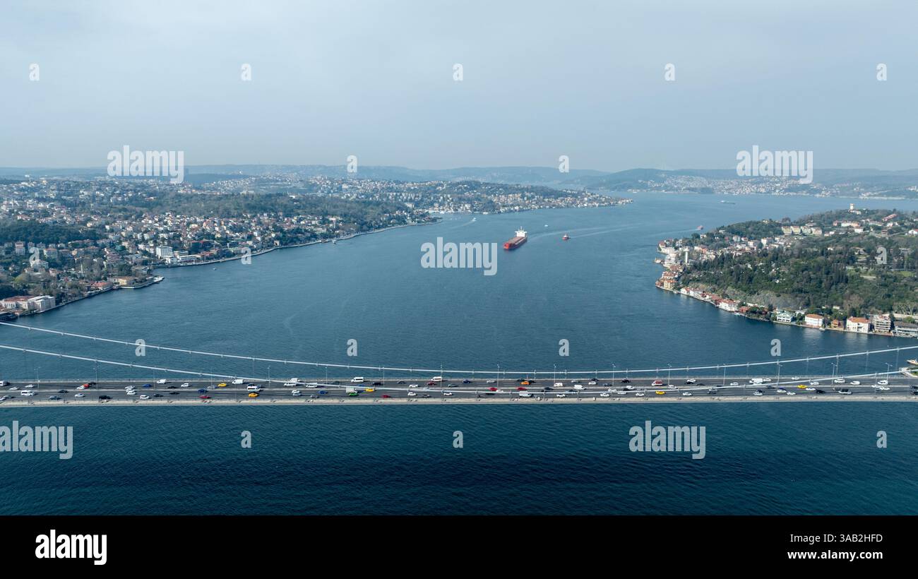 Tanker ship passing under the FSM Bridge with a heavy car traffic on ...
