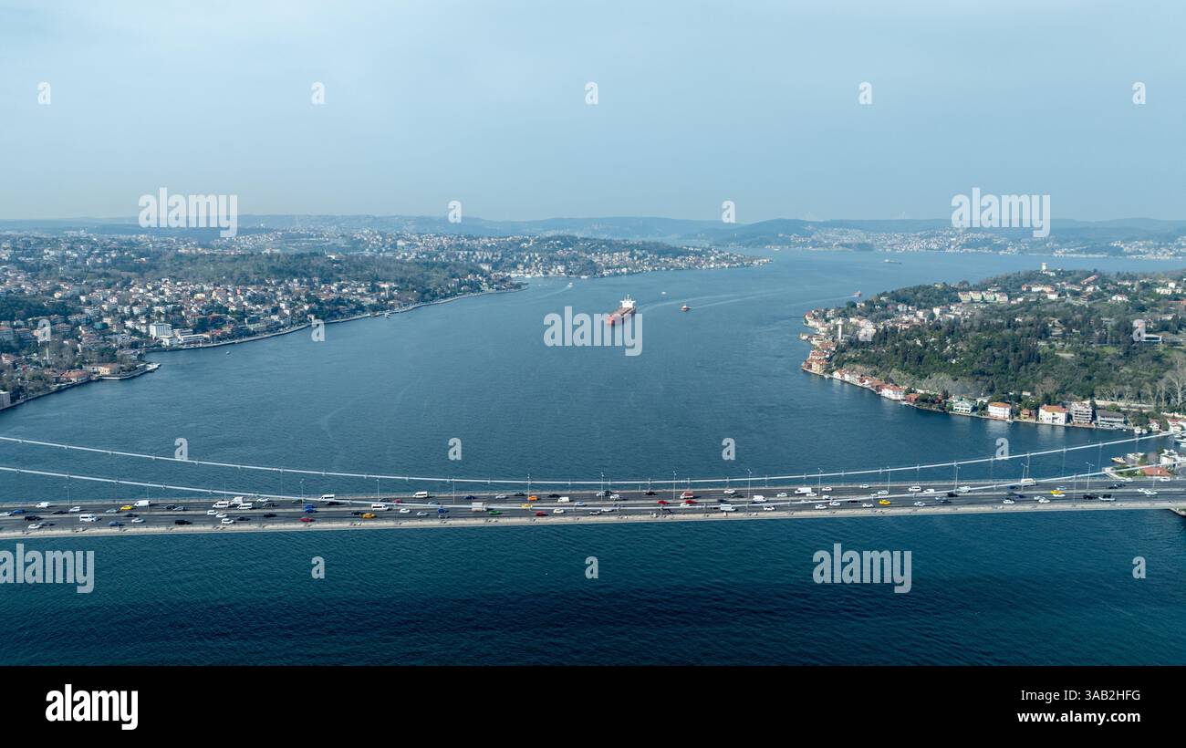 Tanker ship passing under the FSM Bridge with a heavy car traffic on ...