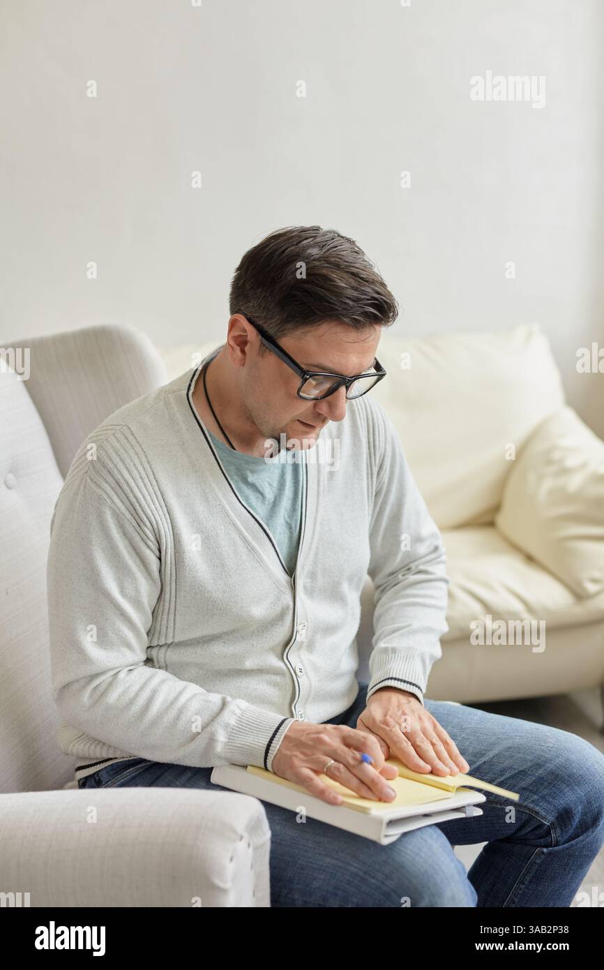 Portrait of handsome male psychologist and taking notes during therapy ...