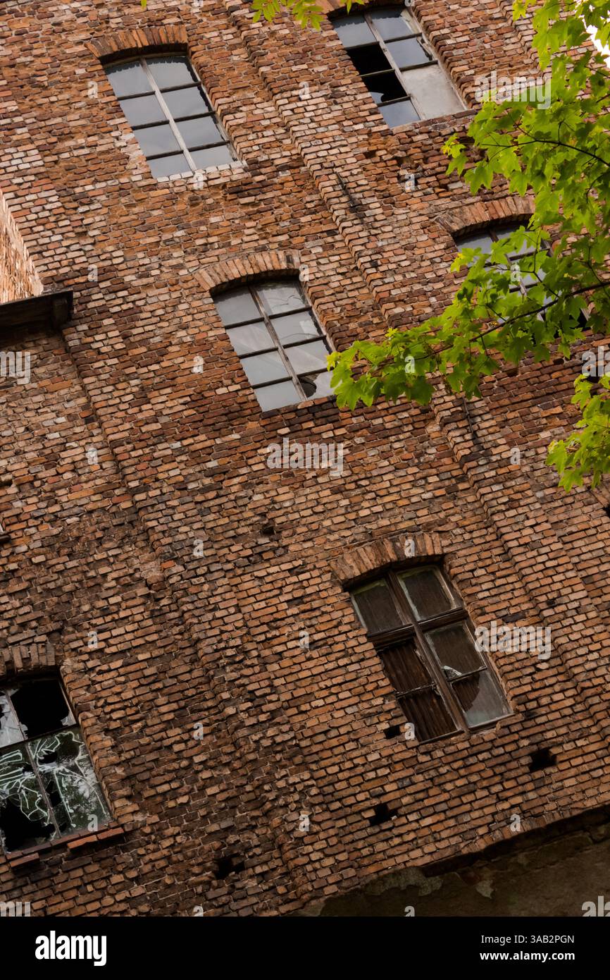 Abandoned European Brick Building with Broken Windows and Overgrown ...
