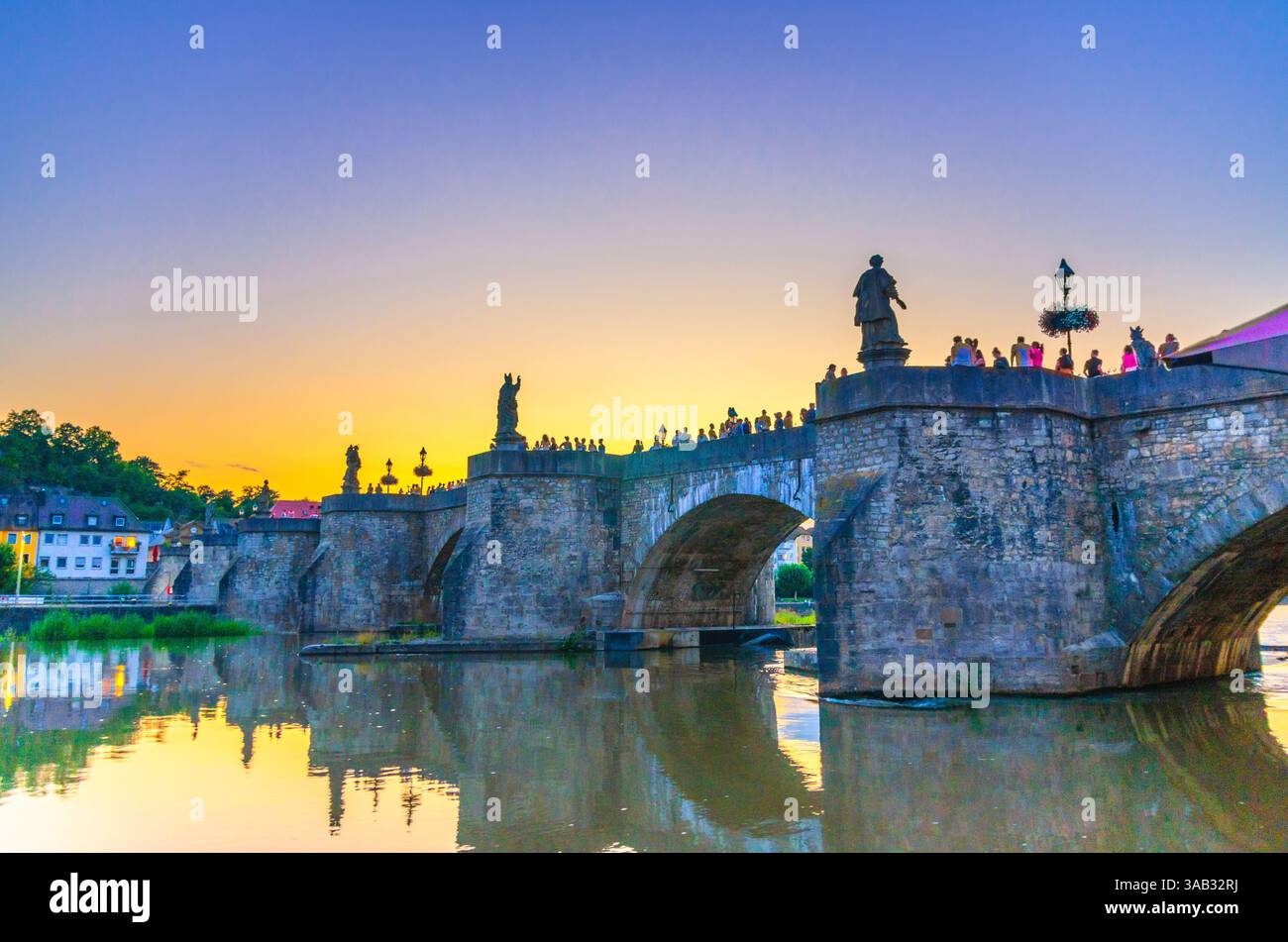 Old Main Bridge across Main river Alte Mainbrucke with statues of ...