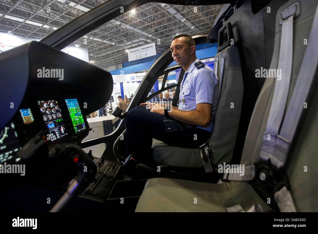 An Air Force member sits in the cockpit of an Airbus H145M helicopter ...