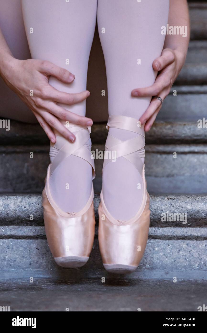 Closeup of ballerina's pointes on the gray stone steps background ...