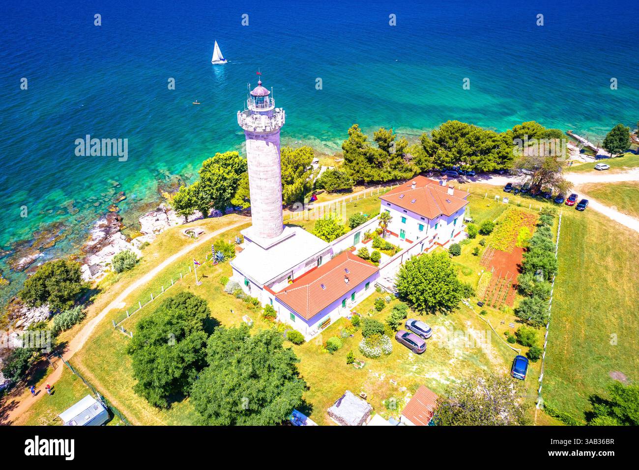 Savudrija lighthouse and turquoise crystal clear rocky beach aerial ...