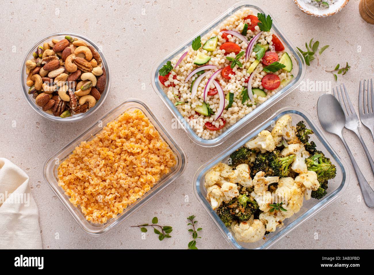 Vegan meal prep in containers with lentils, roasted vegetables, nuts ...