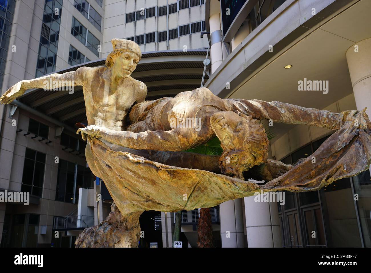 Close up of a gold statue of two dancers, dancing man and woman; modern ...