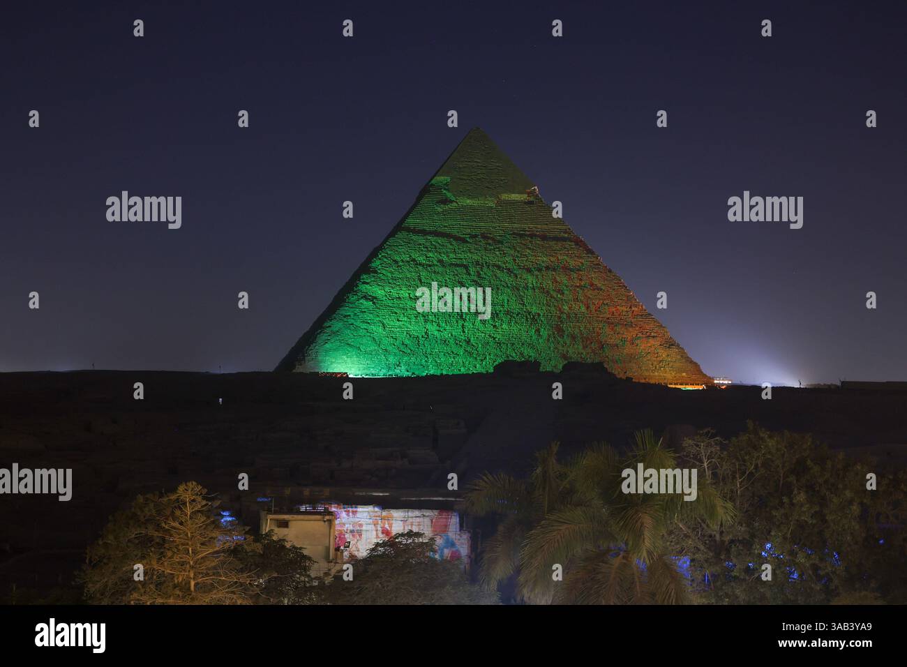 Egyptian pyramid complex in Giza with the largest pyramid illuminated ...