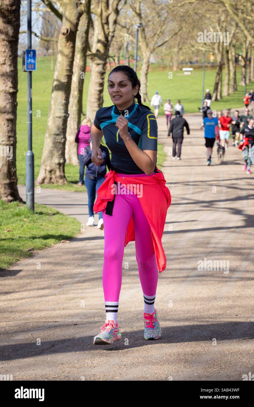 Parkrun at Gladstone Park, London Willesden NW2. A young female Asian ...