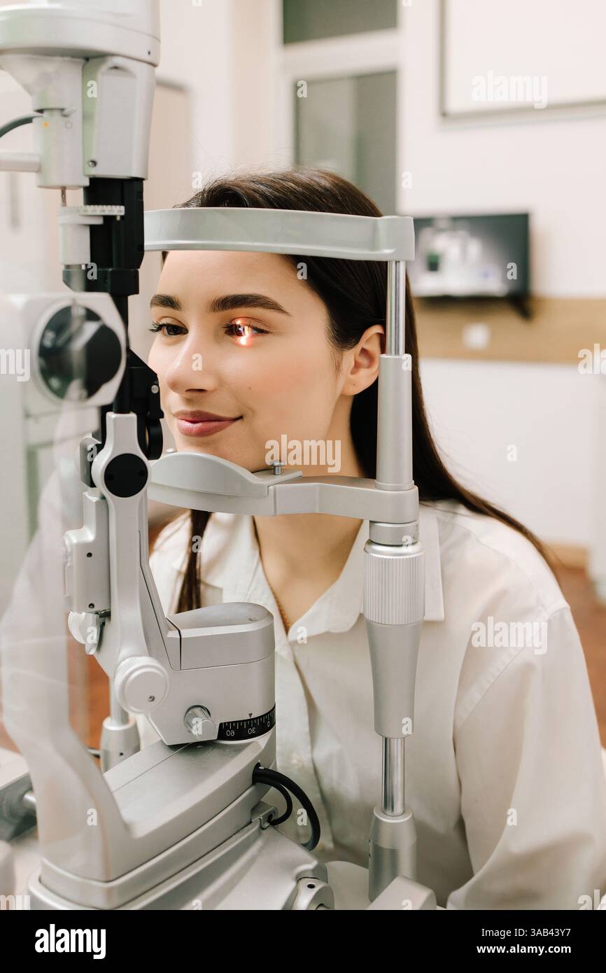 Light on eye from slit lamp for examination eyes and cornea of girl ...