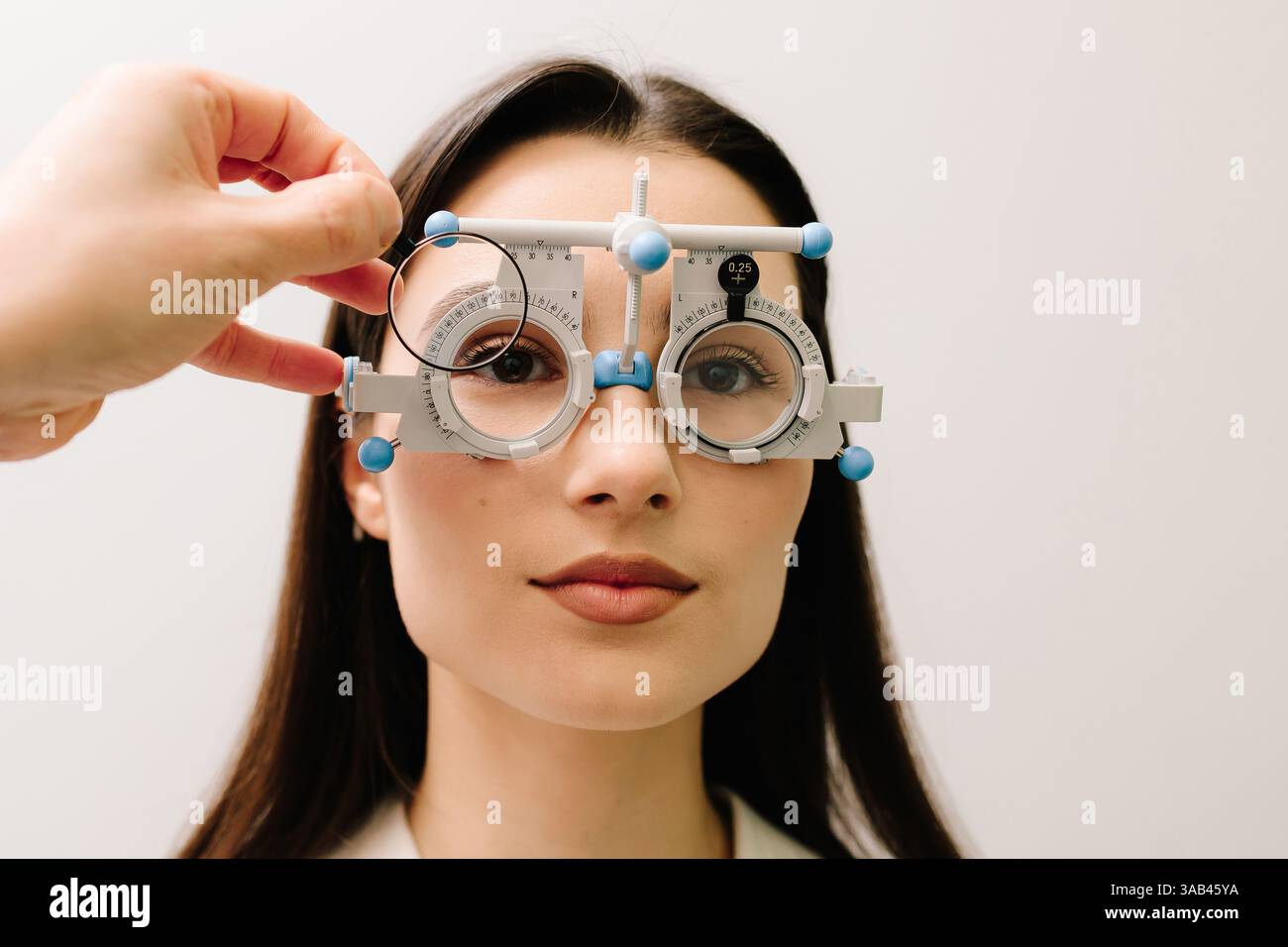 Trial frame glasses to determine the correct prescription lenses. Girl is wearing trial frame ...