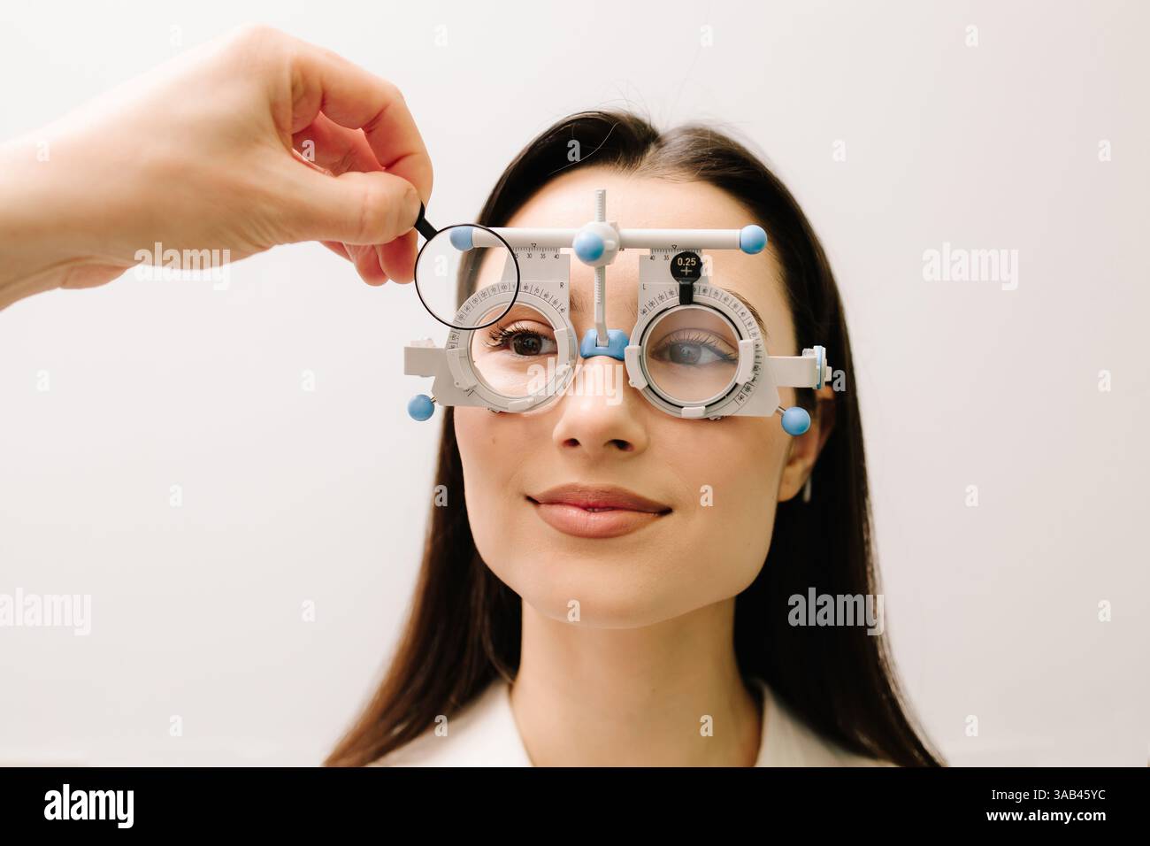 Girl is wearing trial frame glasses for eye exam vision test by ...