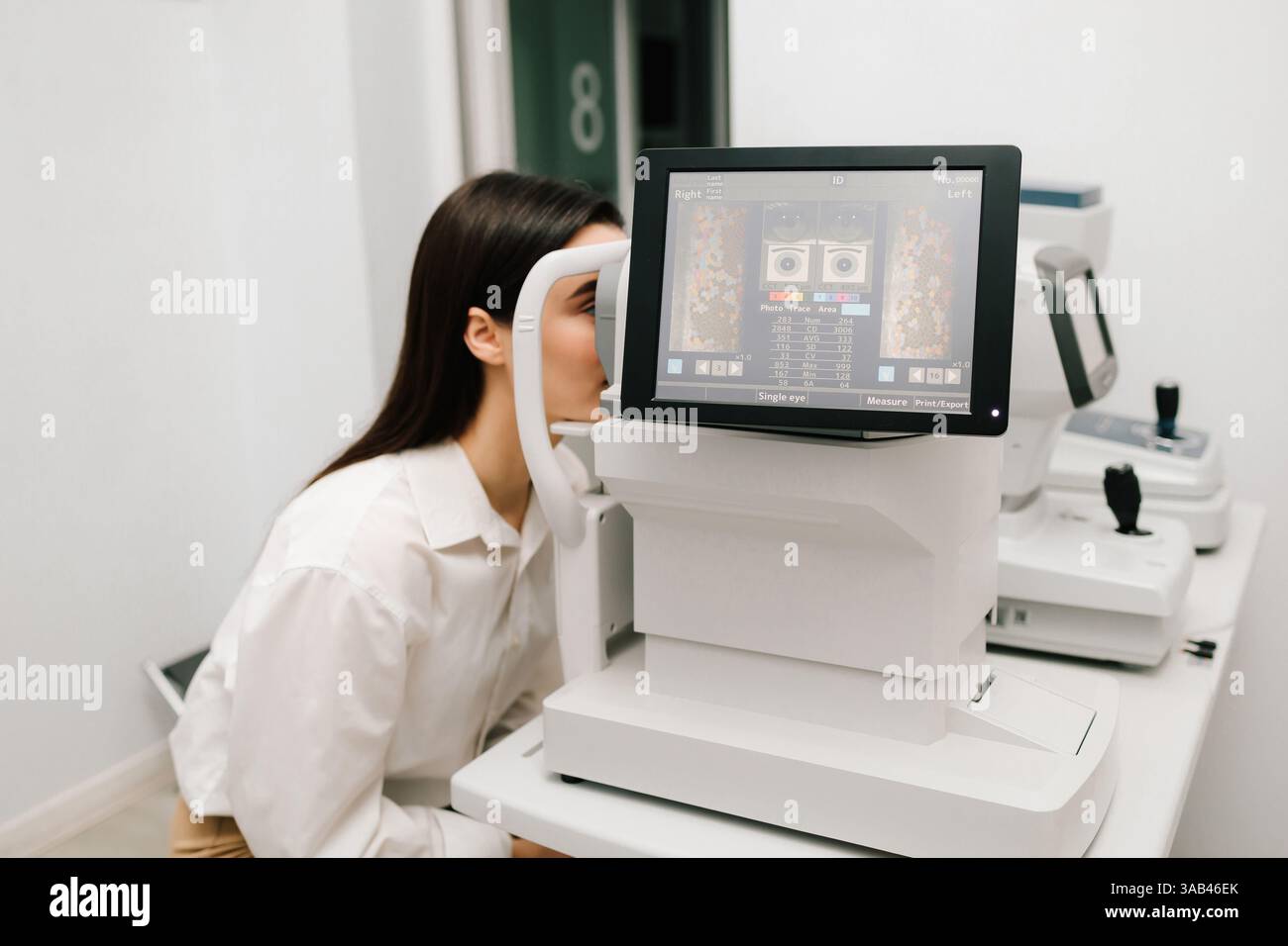 Girl undergoes an OCT eye exam using advanced optical coherence ...