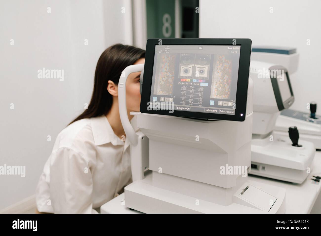 Girl undergoes an OCT eye exam using advanced optical coherence ...
