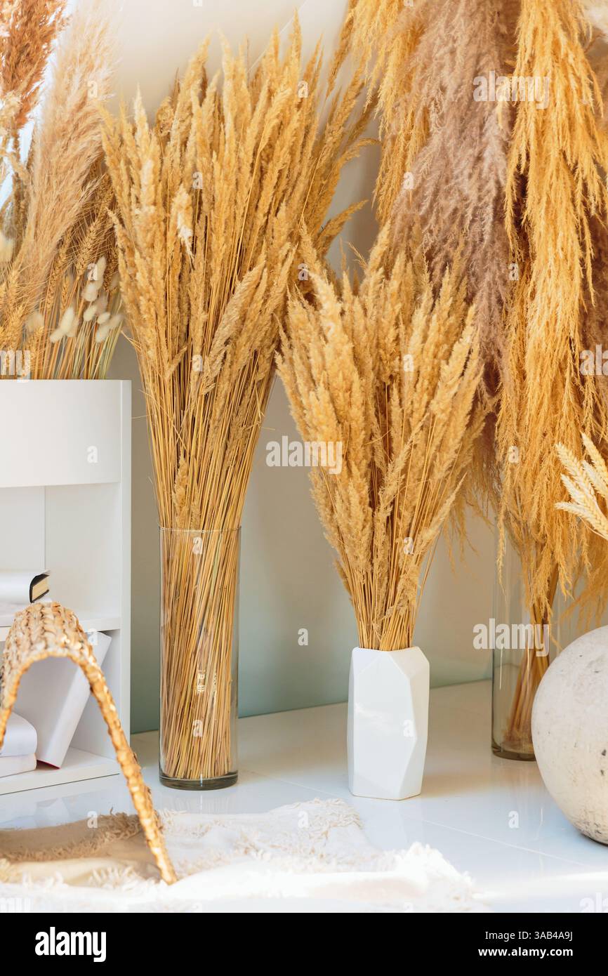 Natural home decor with dried wheat in vases Stock Photo - Alamy