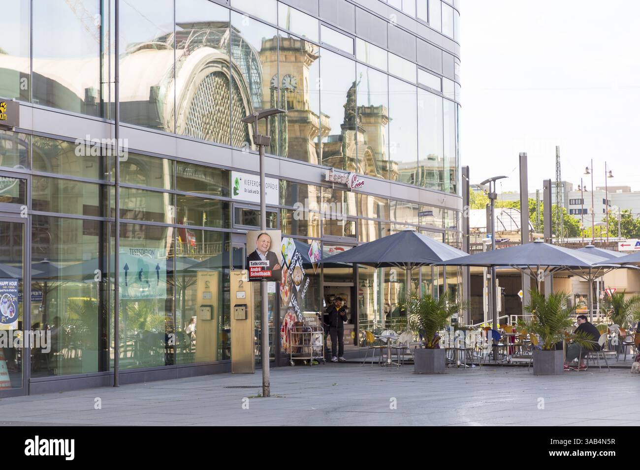 Reflection of the main railway station in the glass facade of the ...