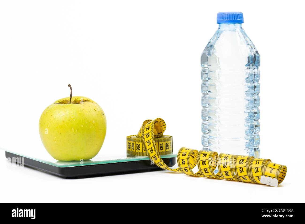 Bottle of water, measuring tape, scale and apple isolated on white ...